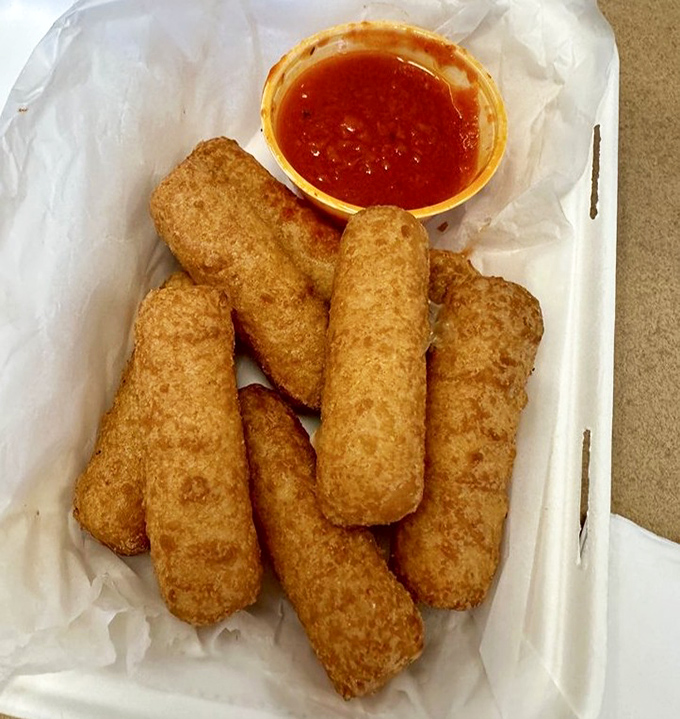 Golden mozzarella sticks that stretch like edible bungee cords, crispy outside and molten within.