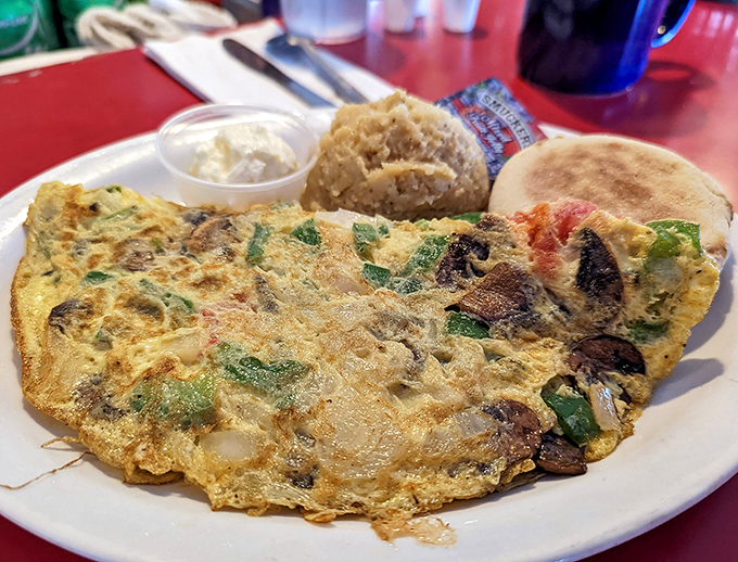 An omelet that's practically a garden on a plate. Whoever said breakfast can't be colorful never started their day at Mrs. Mac's.