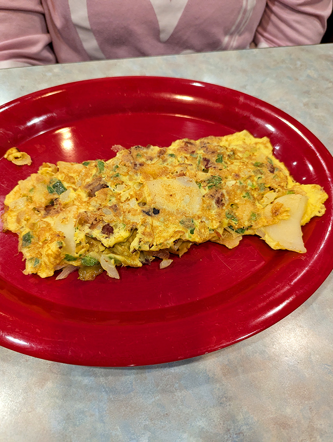 An omelet that's achieved perfect balance&mdash;fluffy eggs cradling a medley of fillings in a display of breakfast engineering.