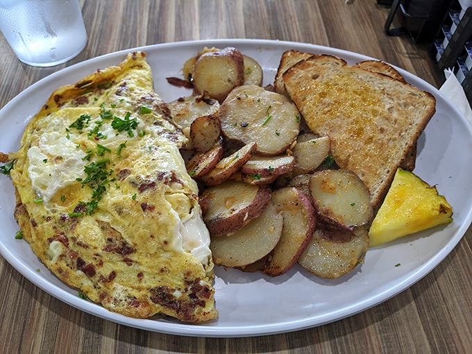 This omelet doesn't just sit on the plate&mdash;it lounges confidently beside golden home fries like it knows it's the star of the show.