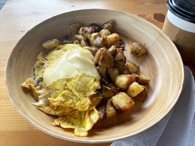 Breakfast alchemy: fluffy eggs and perfectly seasoned potatoes served in a wooden bowl that somehow makes everything taste even better.
