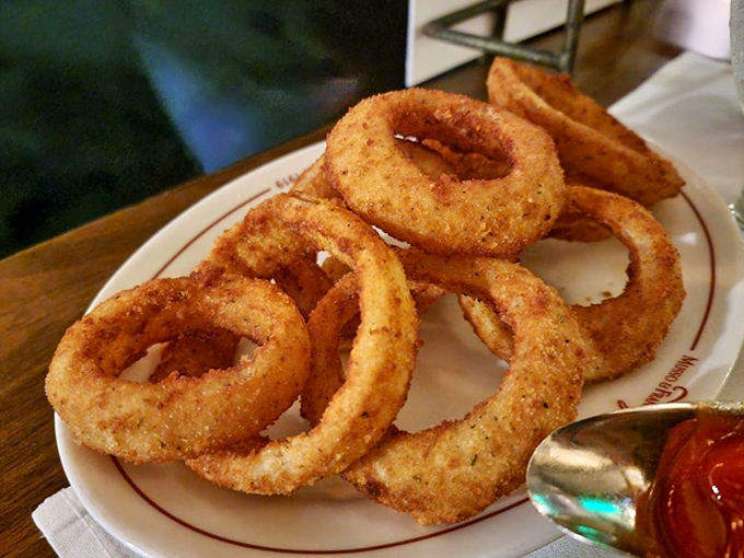 Golden, crispy onion rings stacked like delicious bracelets. These crunchy halos have been tempting diners to break their diets for generations.