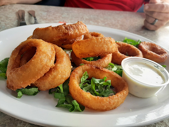 Onion rings with the structural integrity of Olympic medals but infinitely more delicious. That dipping sauce is standing by, ready for its supporting role.