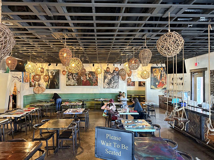 The modern dining room balances rustic charm with artistic flair, creating the perfect backdrop for the food that's about to steal the show.