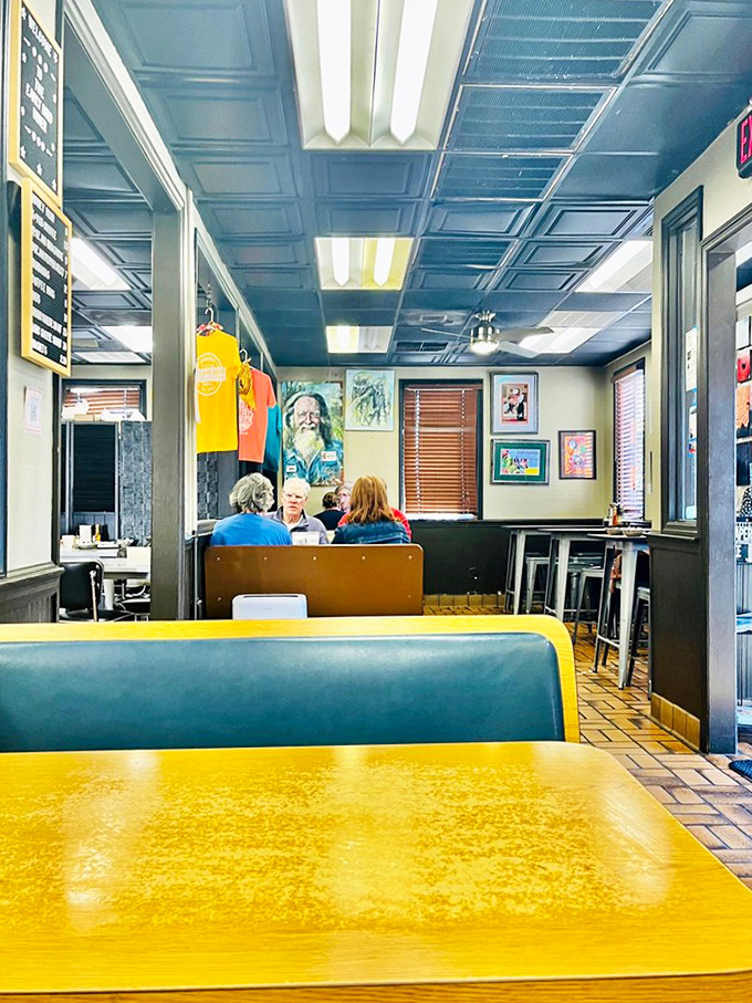Yellow tables and blue booths create a cheerful backdrop for serious eating. This is where breakfast memories are made.
