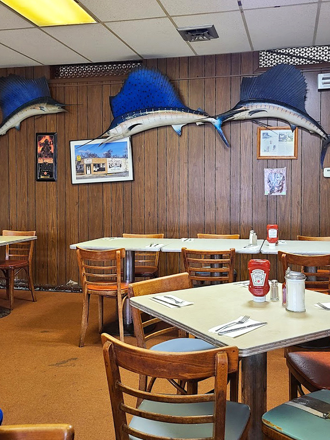 Blue marlins stand guard over the dining room like aquatic sentinels, ensuring every bite of fish meets the Scotty Simpson standard of excellence.