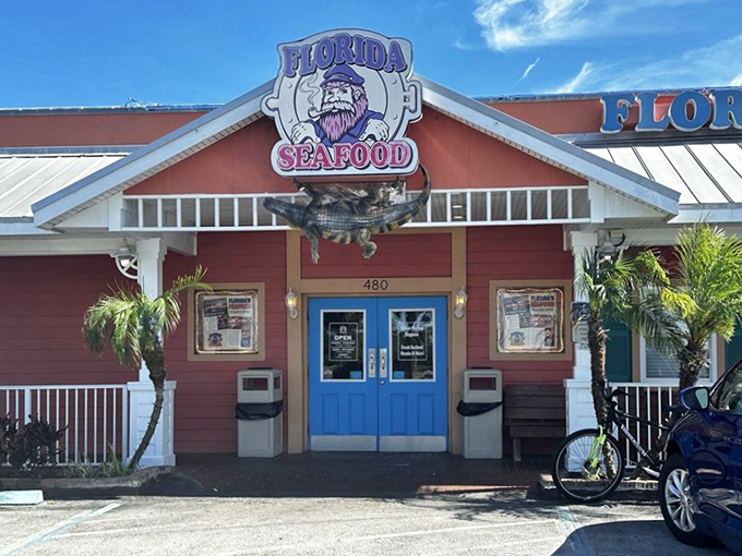 The daytime view reveals a cheerful salmon-colored building that stands out like a flamingo in a penguin convention. Florida architecture at its most unapologetic.