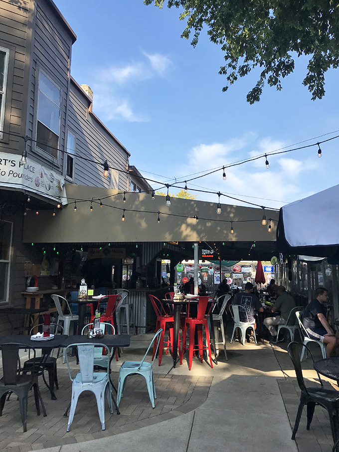 The string-light adorned patio offers a breath of fresh air between slices, where pizza conversations flow as freely as the drinks.