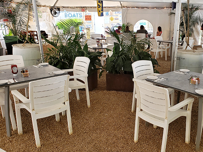 The outdoor dining area offers a breezy escape, where palm fronds and white furniture create a coastal oasis just steps from Annapolis proper.
