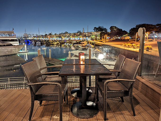 As night falls, the marina transforms into a twinkling wonderland, making outdoor tables the hottest real estate in town&mdash;no broker required.