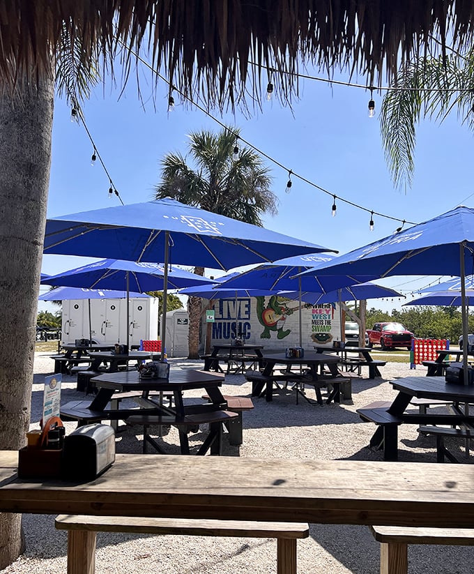 Outdoor seating under blue umbrellas and string lights creates the perfect Florida ambiance&mdash;casual, breezy, and ready for memory-making.