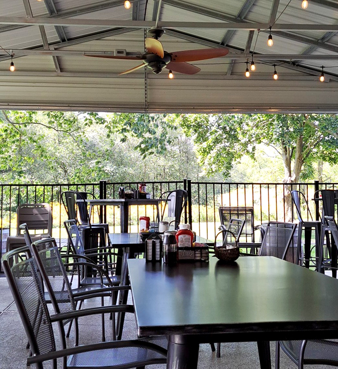 The covered patio offers a serene breakfast retreat with ceiling fans gently stirring the air as you stir your coffee.