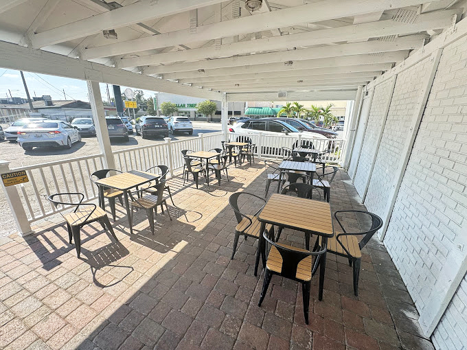 The covered patio offers a perfect spot for enjoying your haul while watching Orlando life unfold&mdash;simple pleasures at their finest.
