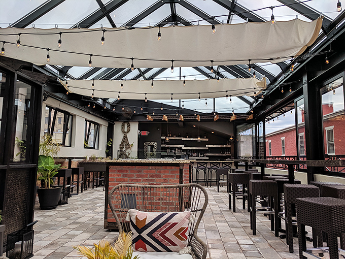 The covered patio brings the outdoors in, creating a year-round alfresco experience without weather worries.