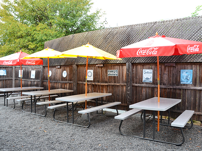 The outdoor seating area &ndash; where picnic tables under Coca-Cola umbrellas create that perfect summer vibe for enjoying sauce-slathered ribs without judgment.