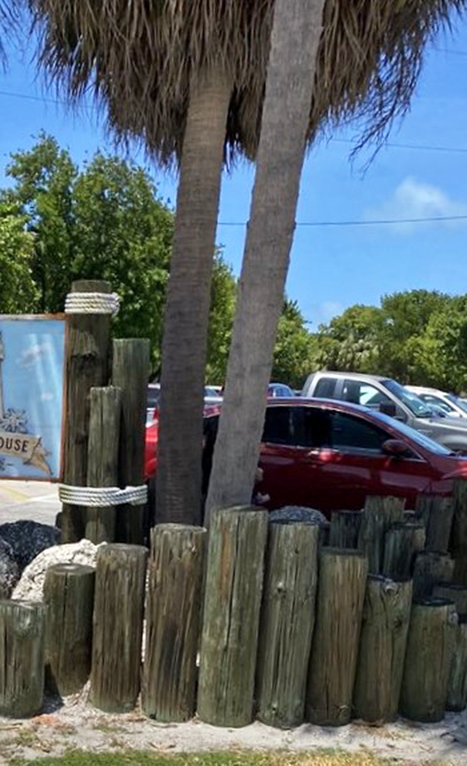 Even the parking area maintains that Old Florida charm, with palm trees standing guard over modern vehicles.