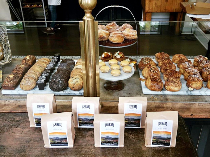 A display case that's essentially a museum of carbohydrate artistry, where each pastry deserves its own tiny spotlight and descriptive plaque.