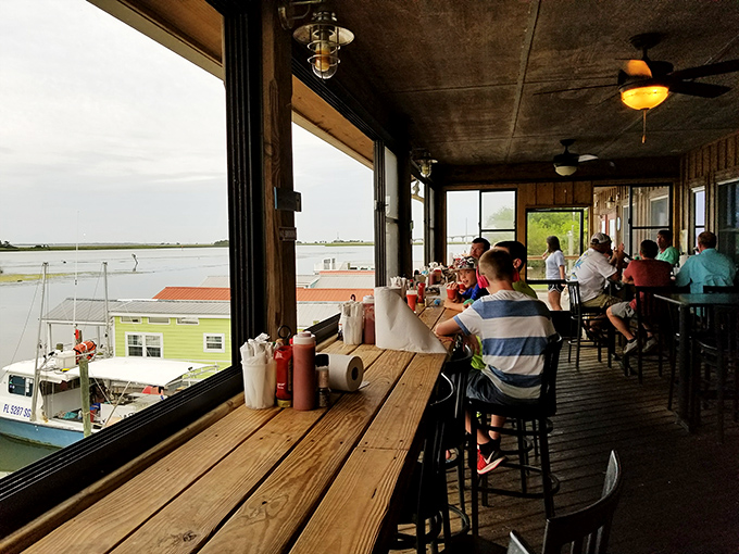 The indoor-outdoor bar seating offers front-row tickets to nature's best show: boats, birds, and the gentle rhythm of coastal life.