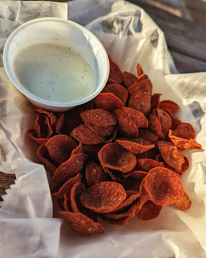 Crispy pepperoni chips with creamy dip&mdash;proof that the simplest snacks often create the most passionate devotees.