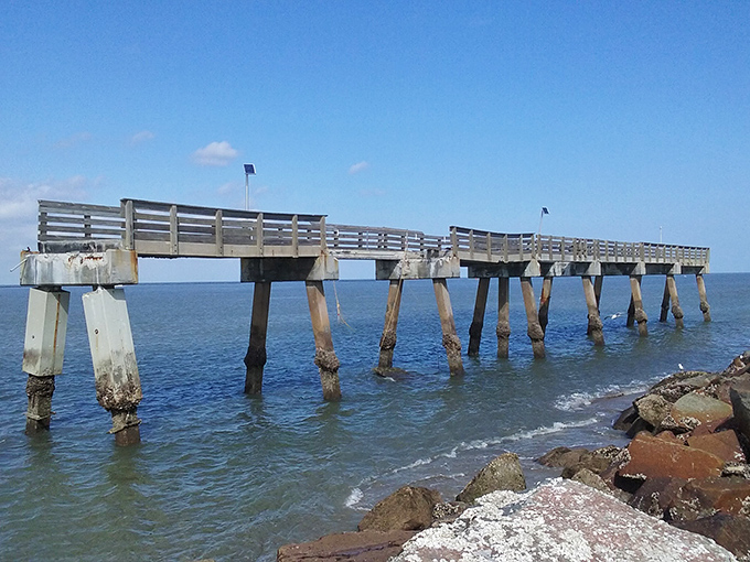 This weathered fishing pier stretches toward the horizon like a wooden welcome mat to the Atlantic. Simplicity that somehow never gets old.