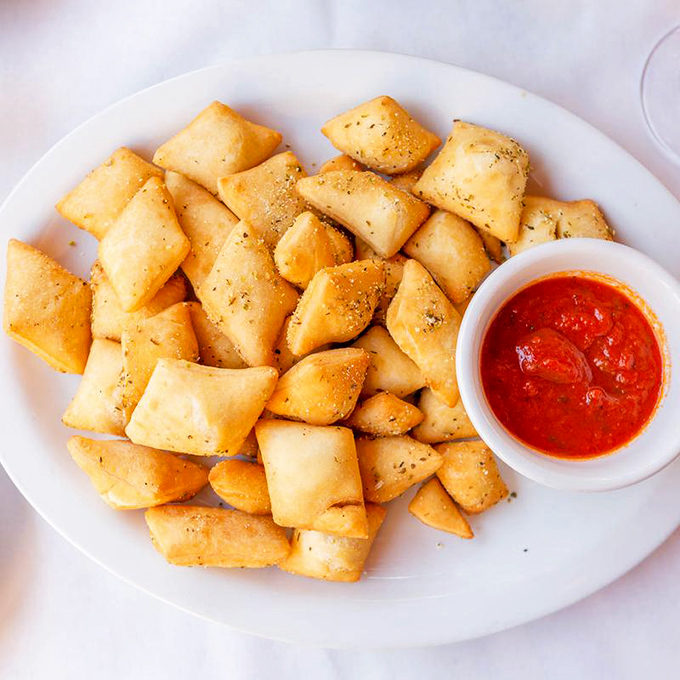 These golden pillows of dough aren't just appetizers&mdash;they're little rectangles of joy, served with marinara that should be bottled and sold as therapy.