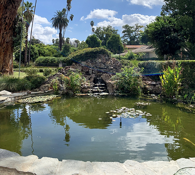 Not your average backyard water feature! This tranquil pond and rock grotto create a reflective moment, both literally and figuratively.
