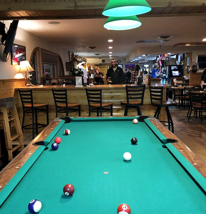 The pool table stands ready for post-dinner entertainment, where friendly competition and digestive pauses go hand in hand.