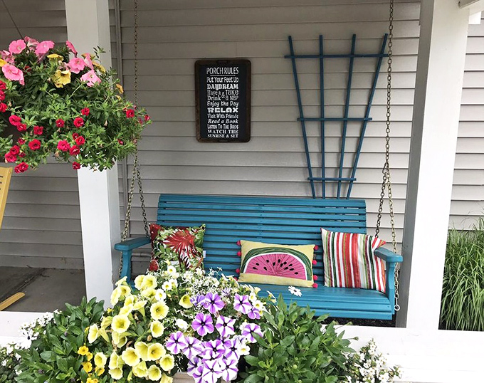 This porch swing practically whispers "stay awhile" – a blue-hued invitation to slow down before or after your meal.