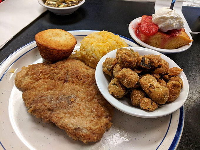A hearty plate featuring what looks like chicken-fried steak, corn nuggets, and cornbread - Southern comfort food's greatest hits album.