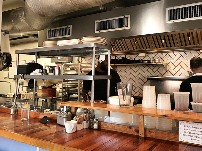 The open kitchen design isn't just practical &ndash; it's dinner theater for breakfast, where stainless steel meets subway tile in perfect harmony.