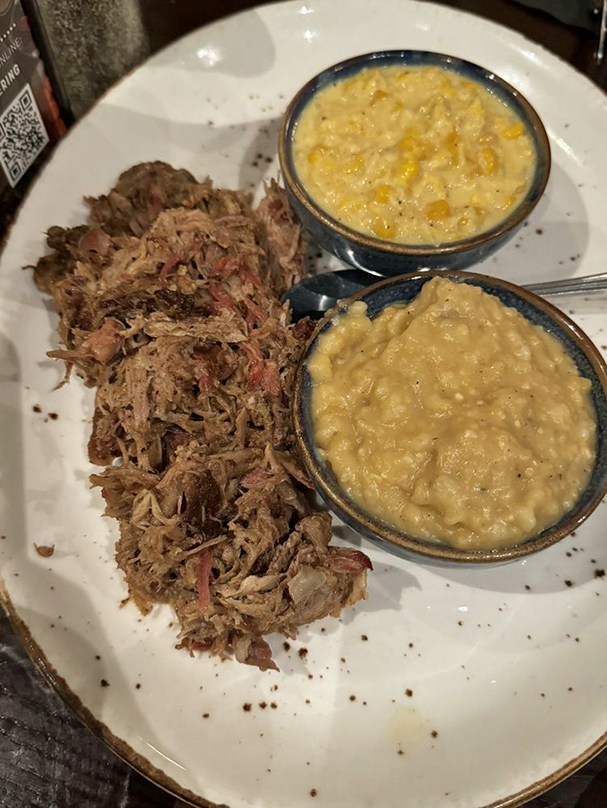 Pulled pork that's spent so much quality time in the smoker it's practically meditation, paired with mac and cheese that's pure comfort.
