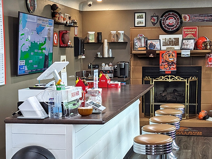Where technology meets tradition at the ordering counter. The fireplace in the background promises the same warmth found in their comfort food.