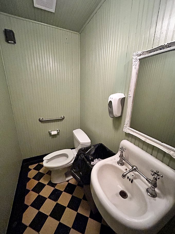 Even the bathroom has character&mdash;mint green walls and checkerboard floors that feel like stepping into your stylish great-aunt's 1950s powder room.