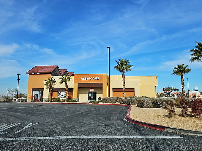 Even the restrooms maintain the desert-chic aesthetic, with palm trees standing guard like sentinels of shopping relief.