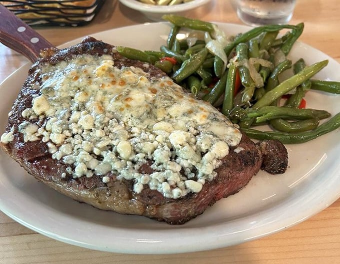 A ribeye topped with blue cheese that doesn't need your approval&mdash;it already knows how good it is. Those green beans provide the illusion of virtue.