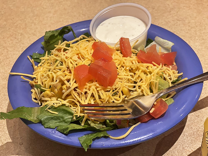 Even the salad gets the royal treatment with a crown of shredded cheese that makes eating vegetables feel like cheating on your diet.