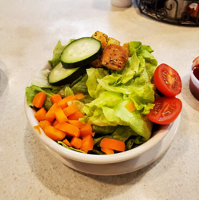 Even the salad looks like it's trying to make amends for all the delicious indulgence happening at the other tables.