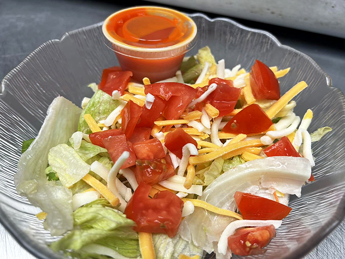 The side salad that doesn't apologize for being healthy. Fresh, crisp vegetables with a splash of color that somehow feels right at home next to a burger and fries.