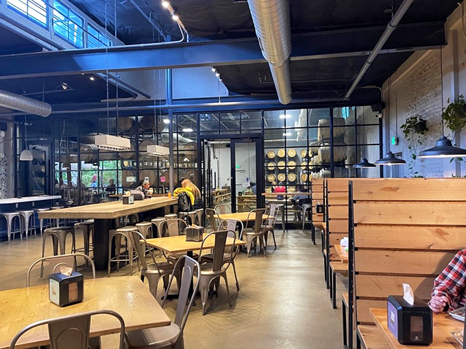 Modern industrial meets warm hospitality in a dining room where the glass walls let you watch the brewing magic happen.