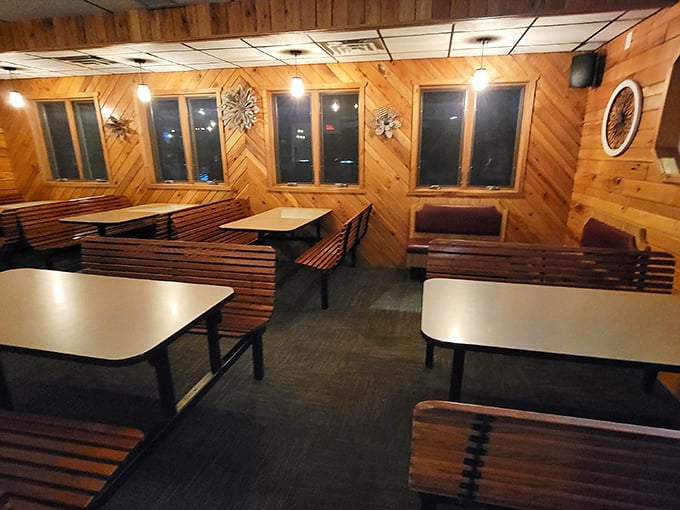 The dining area waits in quiet anticipation of the evening's festivities. These wooden booths have witnessed countless anniversaries, birthdays, and first dates.