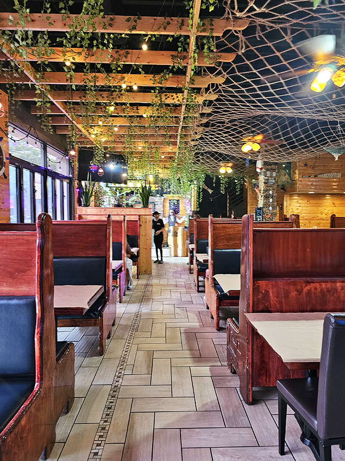 Cozy booth seating encourages lingering conversations over cracked shells and shared stories of culinary conquest.