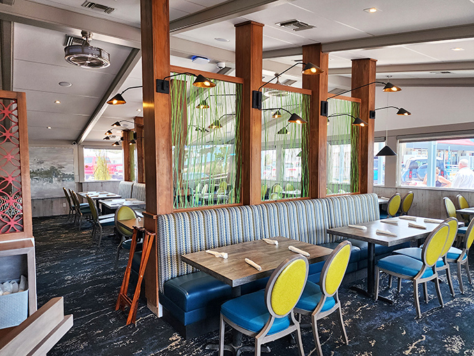 Modern coastal chic meets old Florida charm in a dining room where the blue chairs pop against wooden accents like the Gulf against the shoreline.