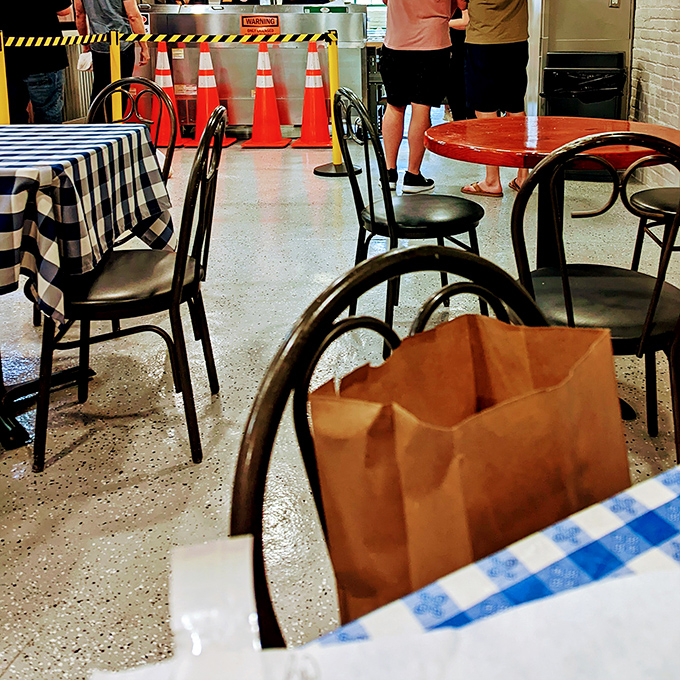 Indoor seating with checkered tablecloths &ndash; where construction workers and office folks unite over sandwich appreciation.