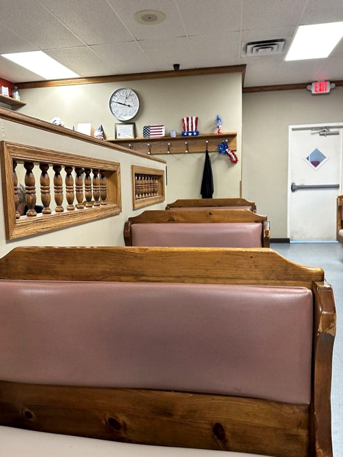 Pink vinyl booths that have cradled generations of diners, beneath walls adorned with subtle patriotism and practical timekeeping.