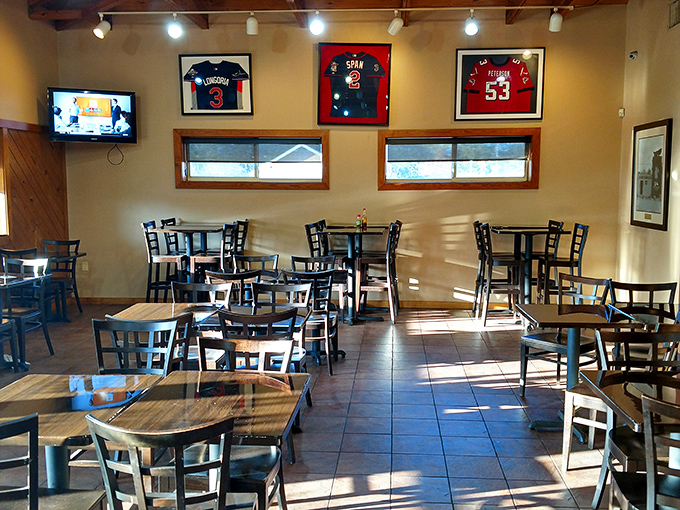 Simple tables and chairs where millionaires and mechanics share the same sauce-covered smile of pure satisfaction.