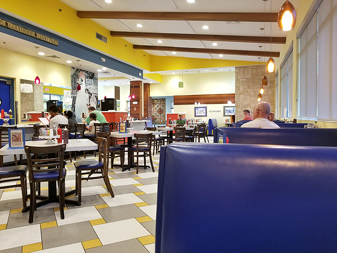 The spacious dining room combines comfort with casual charm. Those blue booths have cradled countless happy diners through epic breakfast sessions.