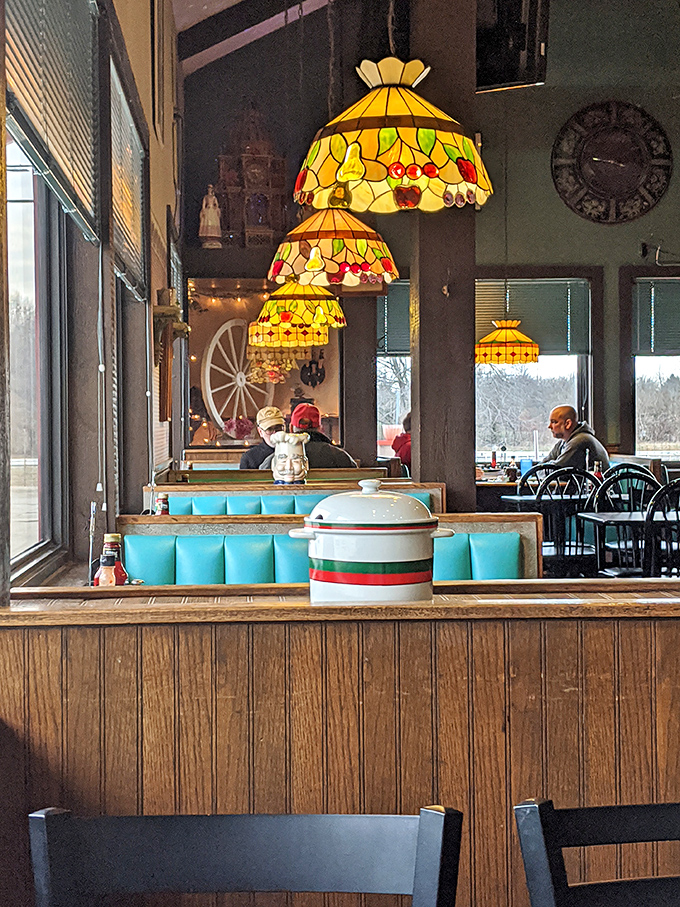 Stained glass pendant lamps cast a warm glow over turquoise booth seating. Diners don't need to be fancy to have character&mdash;this place has it in spades.