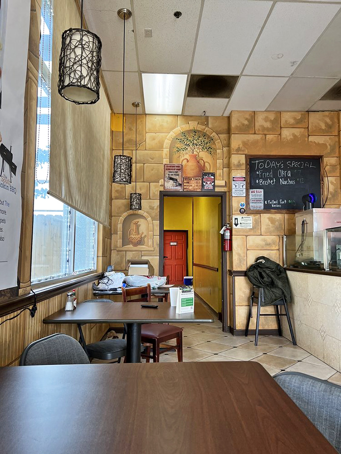 Faux-stone walls and simple seating create that "focus on the food" atmosphere where conversation flows as freely as the barbecue sauce.