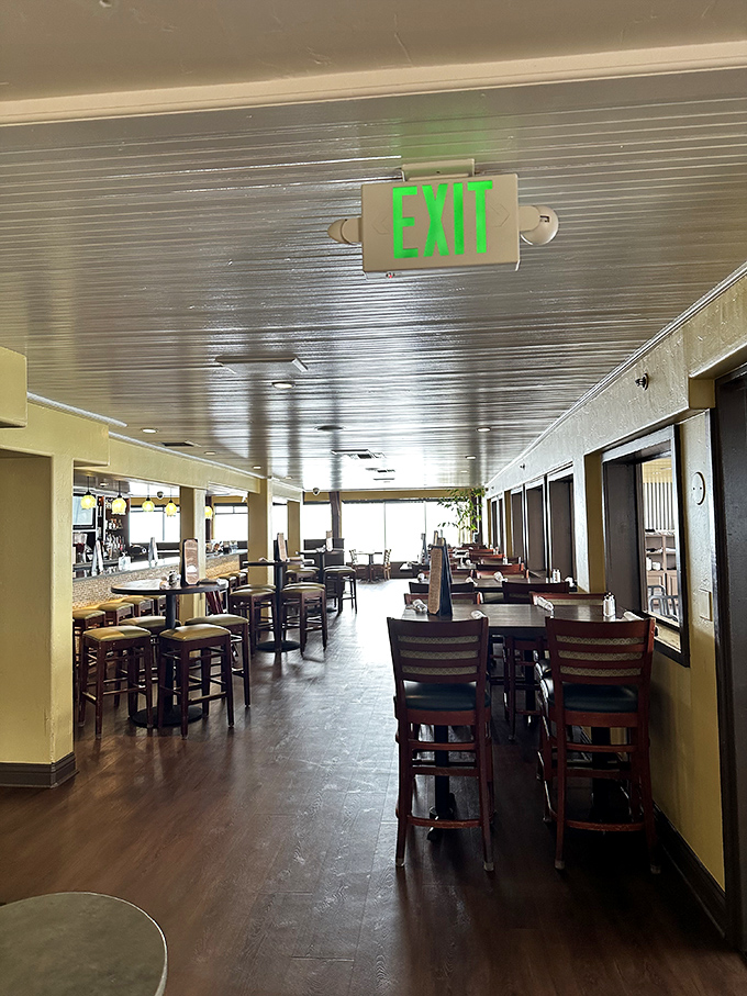 The dining room stretches toward the horizon, drawing your eye (and appetite) toward the Pacific views waiting beyond those windows.