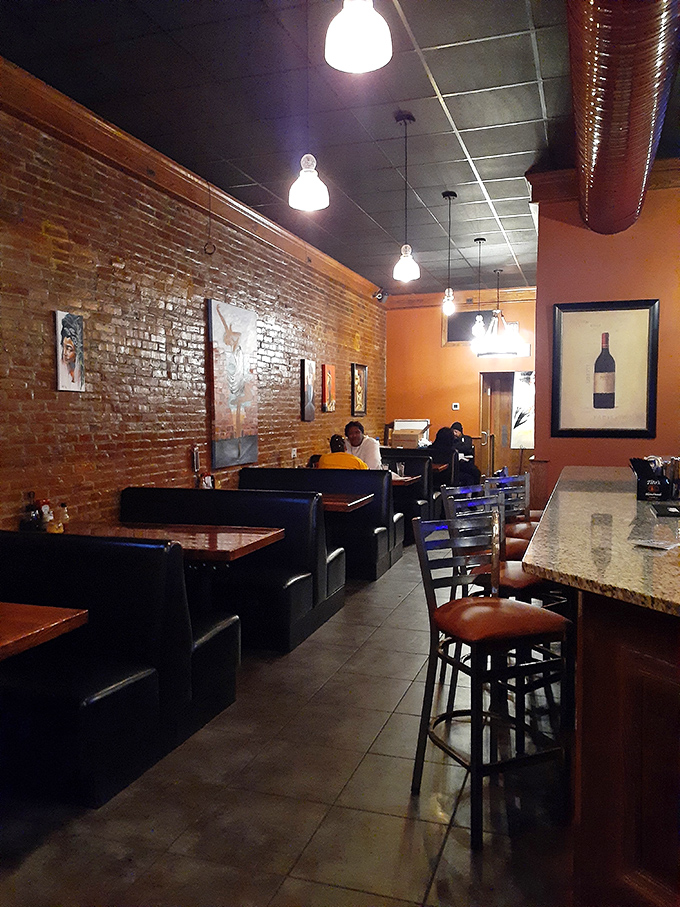 Exposed brick walls, comfortable booths, and warm lighting create the perfect backdrop for the serious business of enjoying exceptional comfort food.